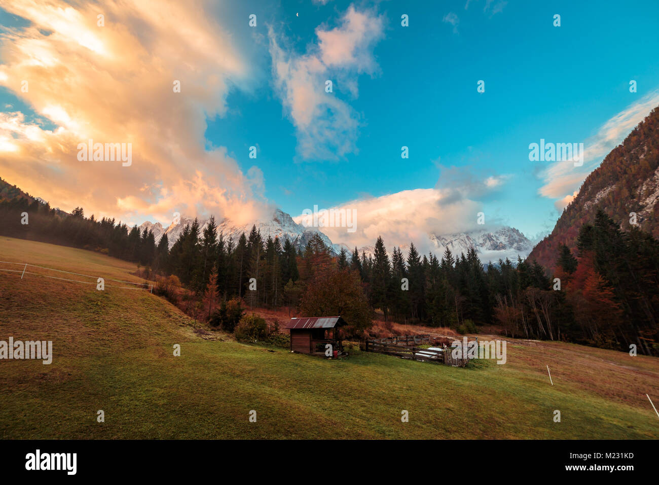 an alpine hut in the valley during a colorful sunrise Stock Photo - Alamy