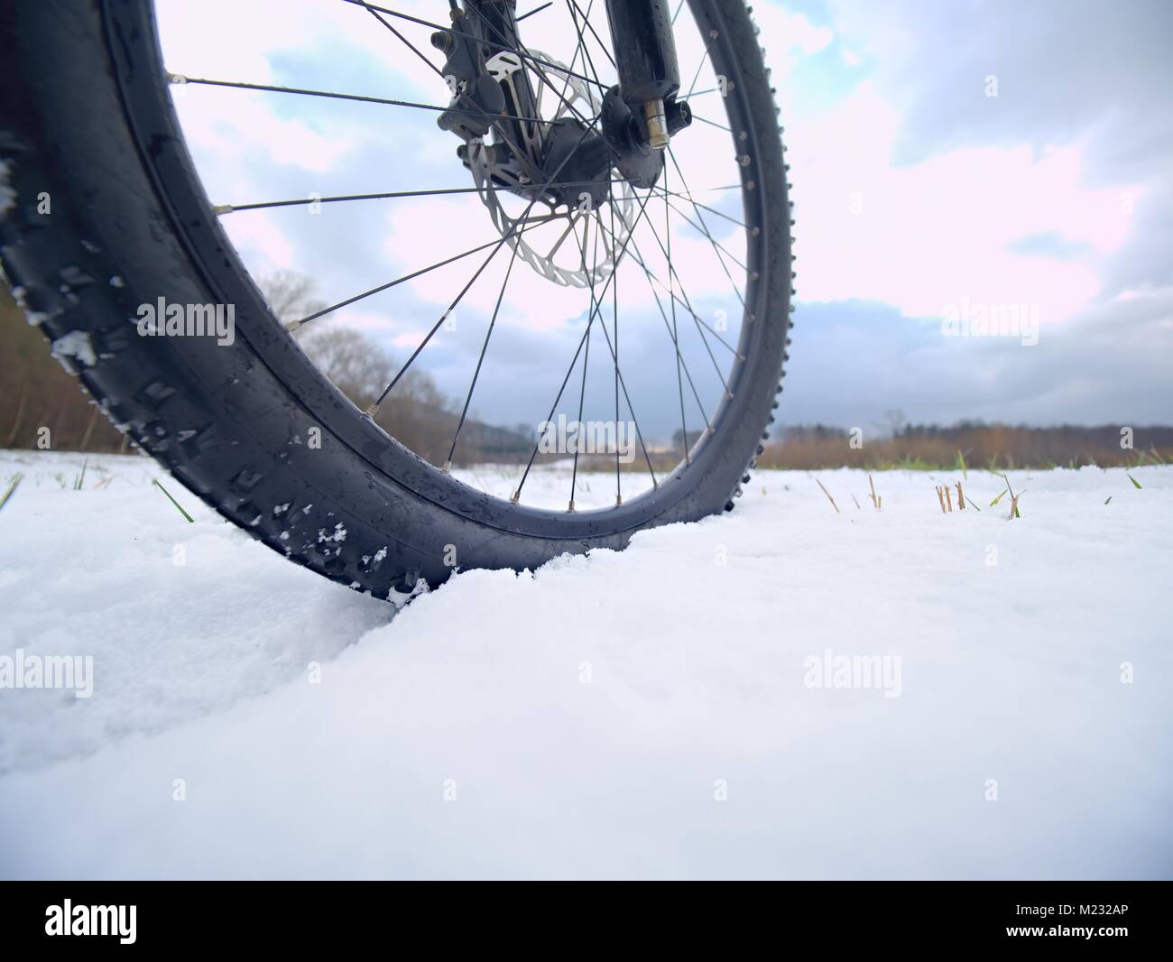 Winter snow riding on mountine bike. Extreme weather, slippery road in ...