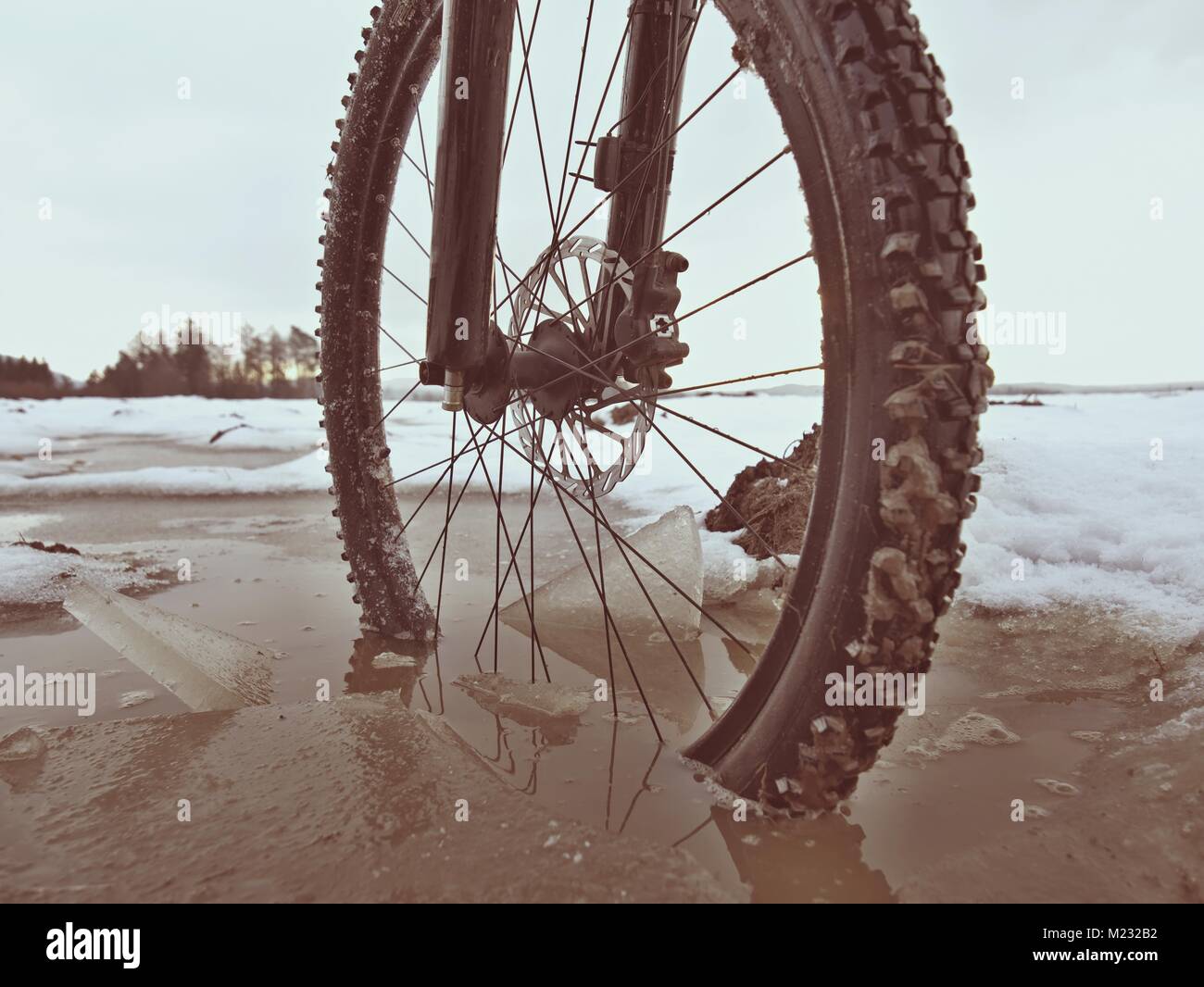 Mountain bike wheel broke through the ice into the water. Enjoy winter ...