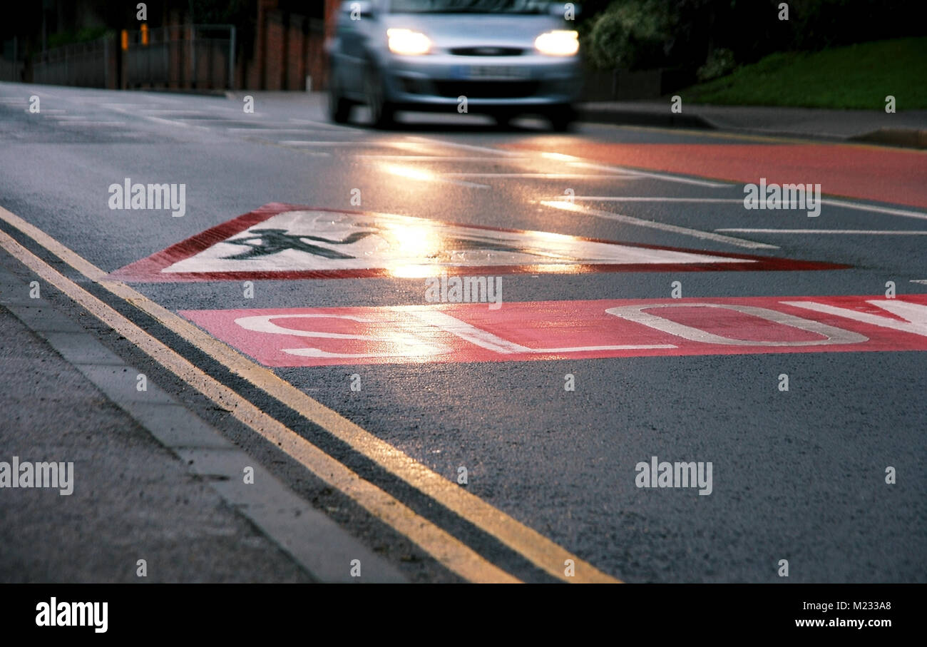 The speed limit signage on the asphalt road, slow, at school zone ...