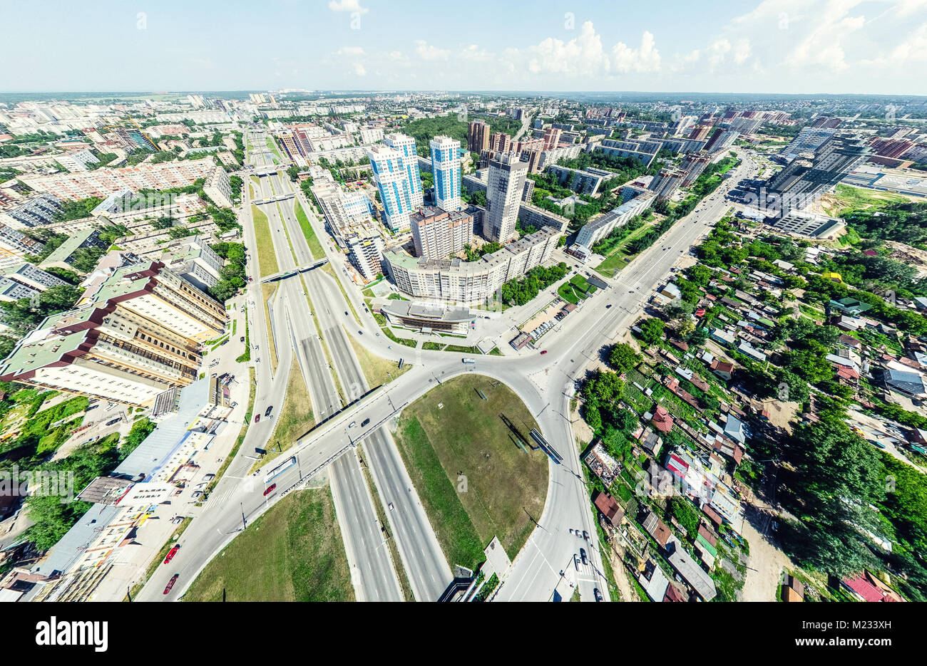 Aerial city view with crossroads and roads, houses, buildings, parks ...
