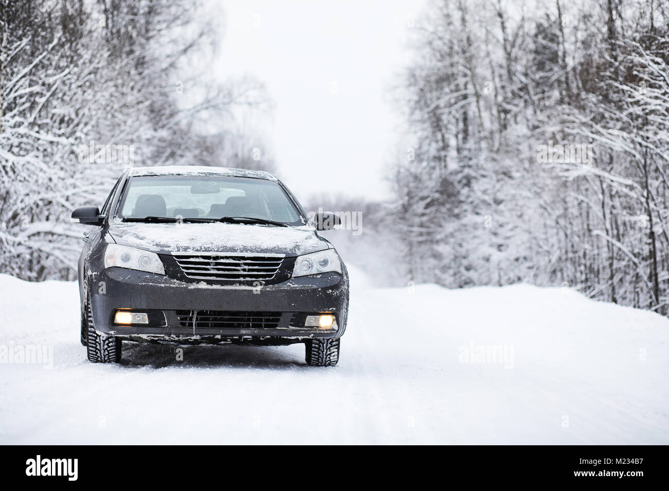 The car stands on a snow-covered road Stock Photo - Alamy