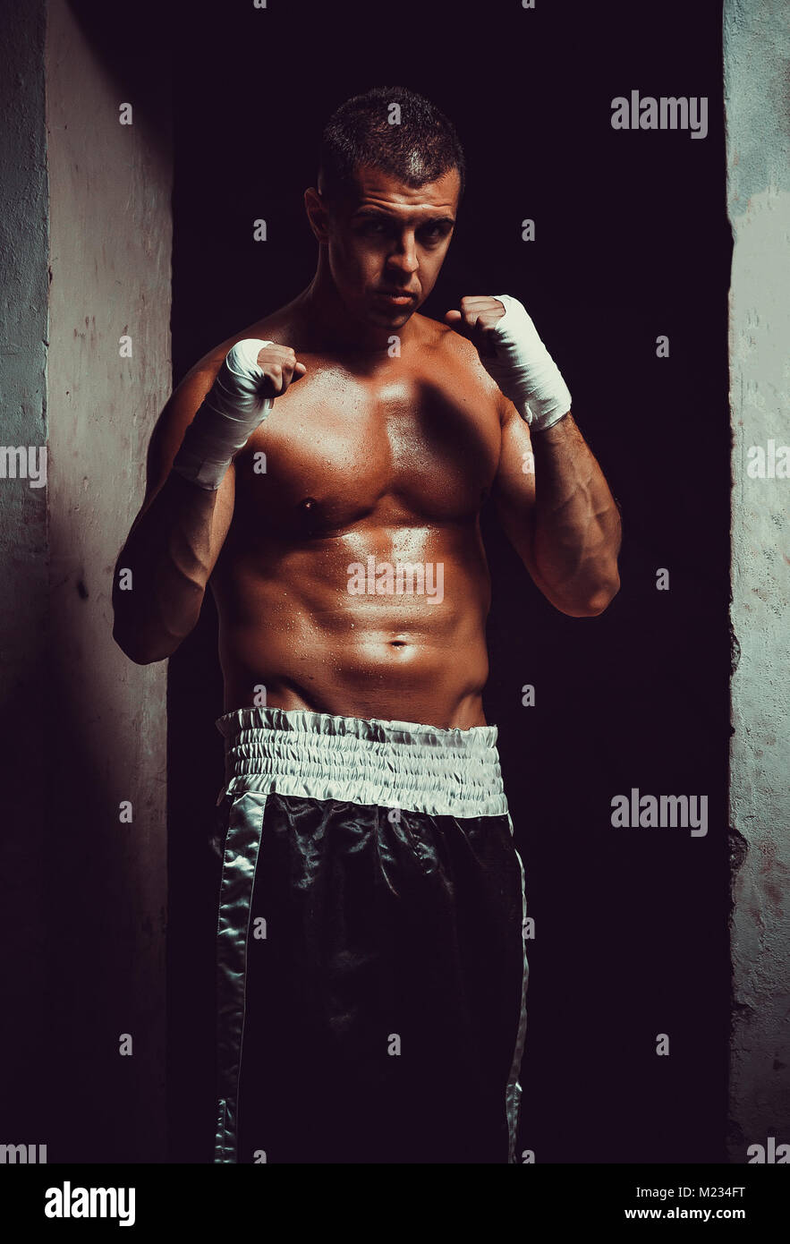 Muscular young man boxer wrapping hand with bandage. Fighter Man ...