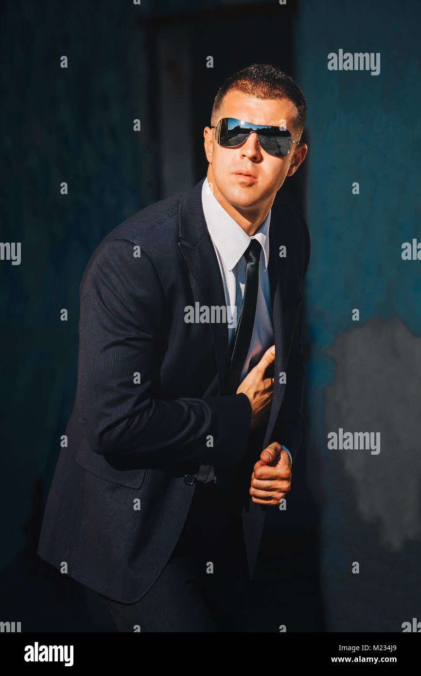 Handsome man in black suit and sunglasses. Secret agent, mafia ...