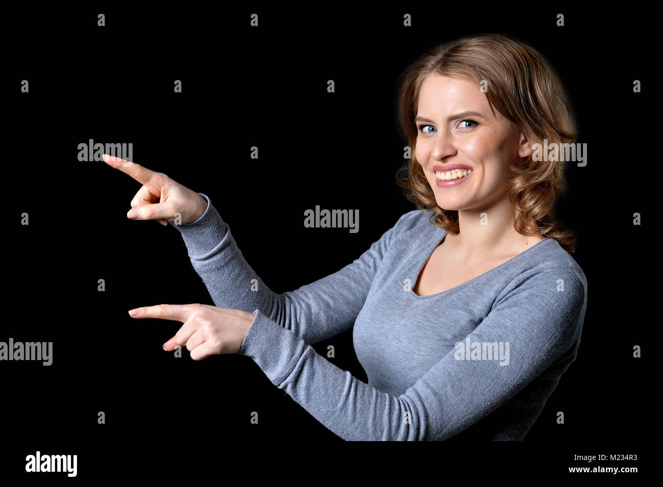 young woman showing something Stock Photo - Alamy