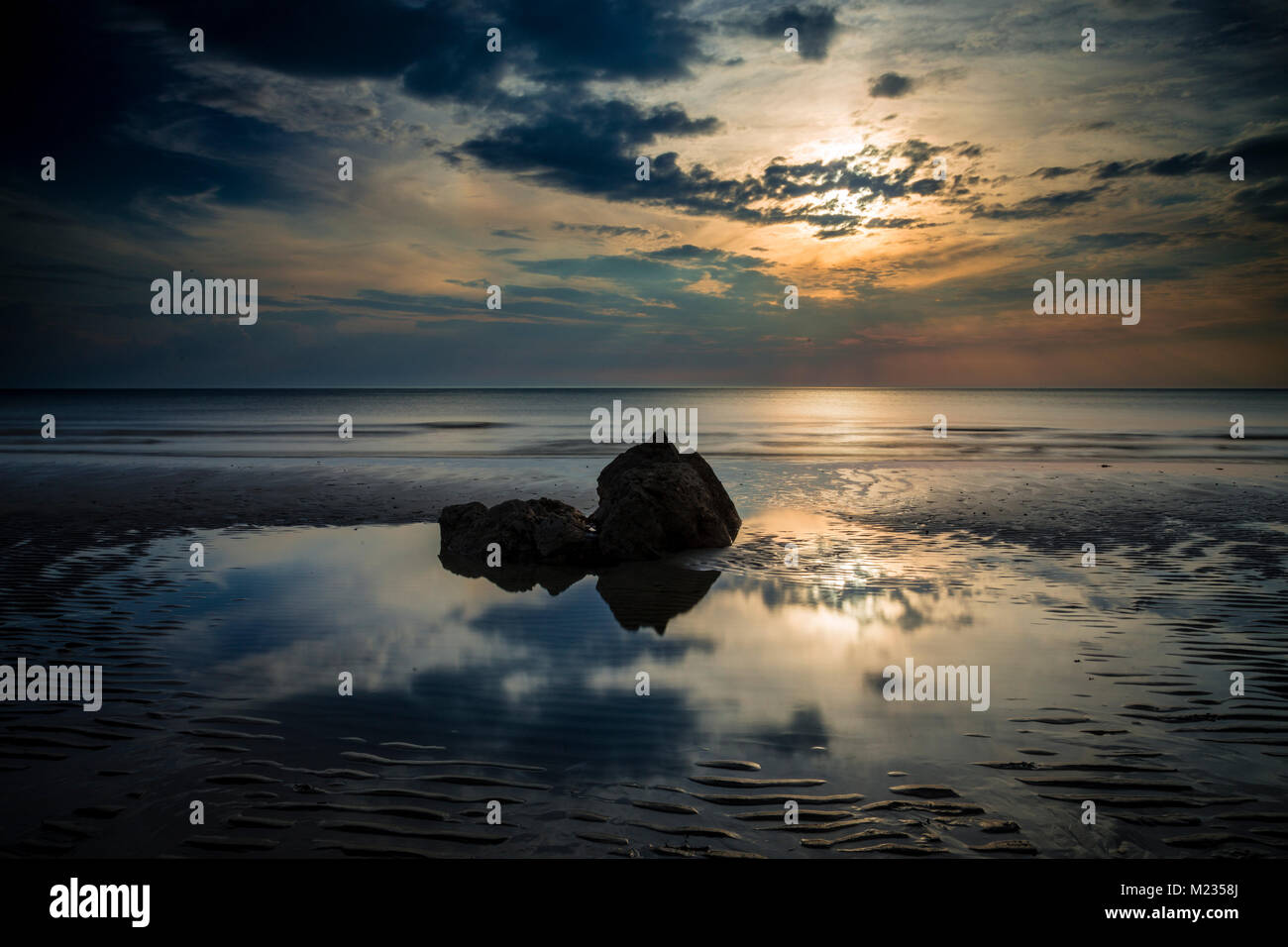 Rock and pool on the beach at Church Bay, Anglesey, North Wales at ...