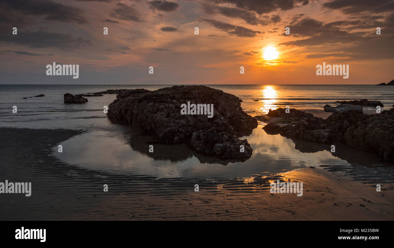 Rocks and pool on the beach at Church Bay, Anglesey, North Wales at ...