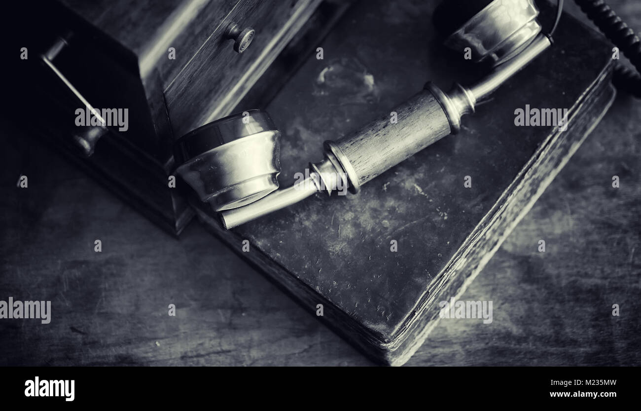 Old telephone and retro book on the desk. The phone of the past Stock ...