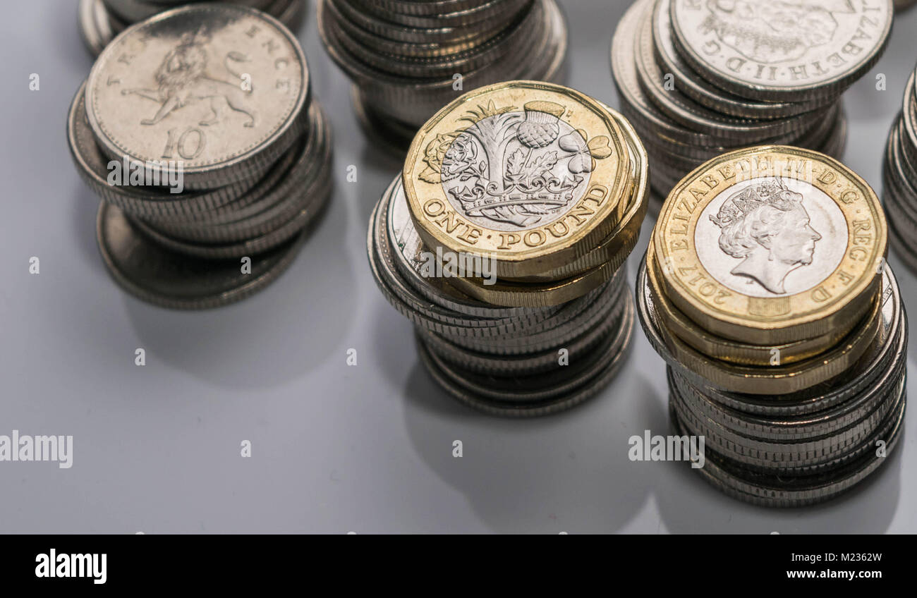 Stacks of different British coins on a white background Stock Photo - Alamy