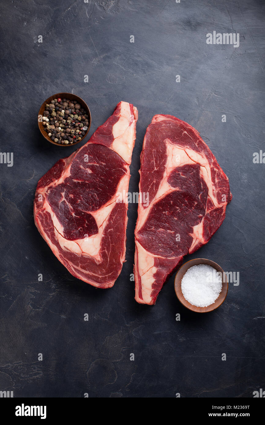 Raw fresh marbled meat Steak Ribeye Black Angus on black marble ...