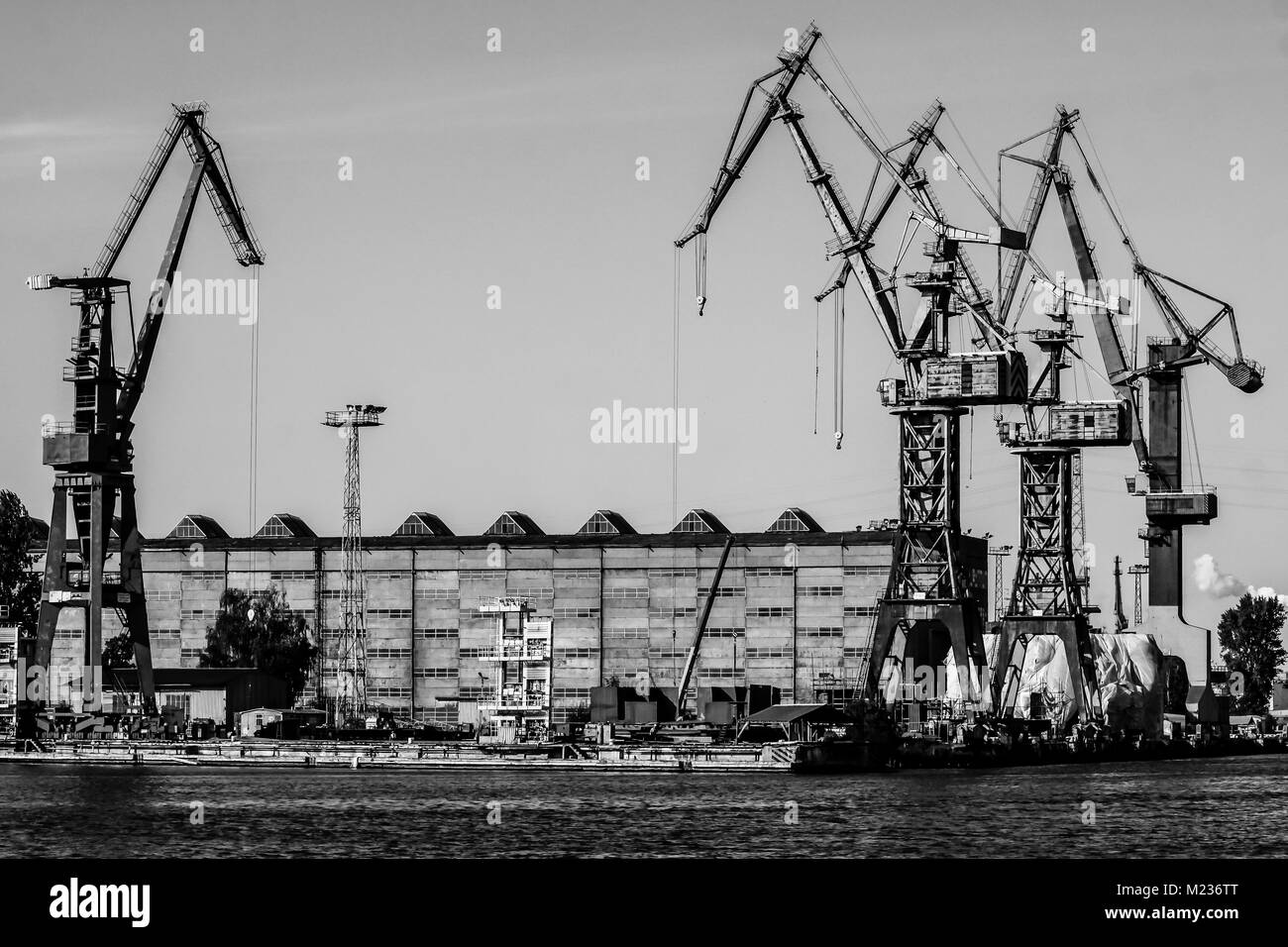 Gdansk shipyard, Poland. Retro style black and white. Cranes, old ...