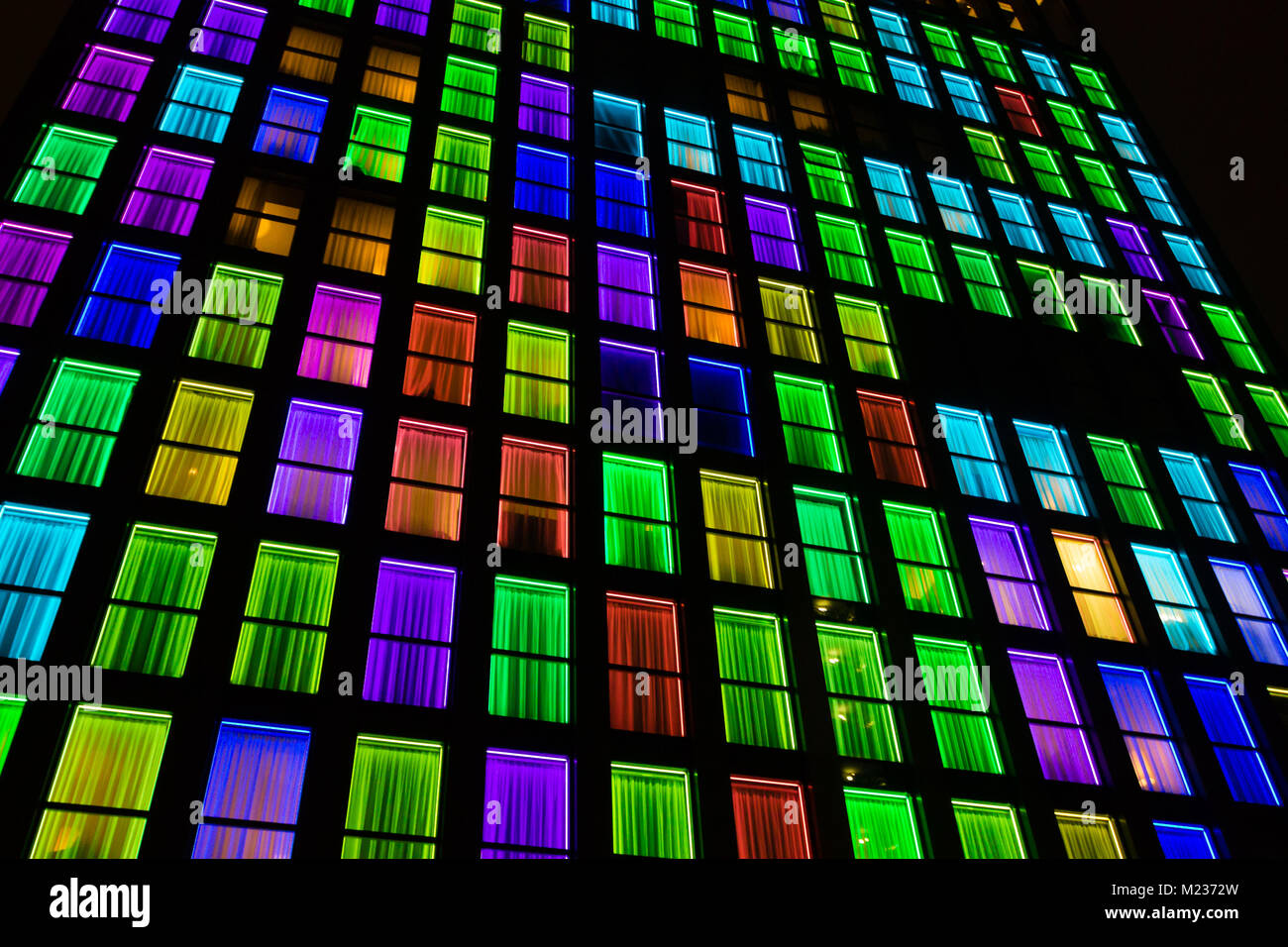 Colored windows texture. Windows illuminated by neon lights background ...