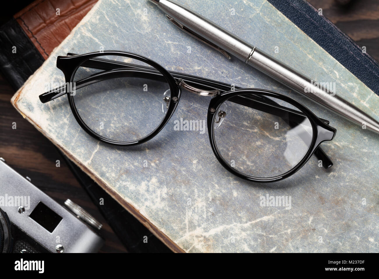 Retro table with vintage items. Camera, books, glasses, Top view Stock ...