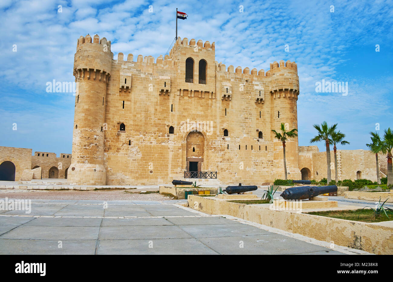 The facade of Qaitbay castle with towers from each side, battlements ...