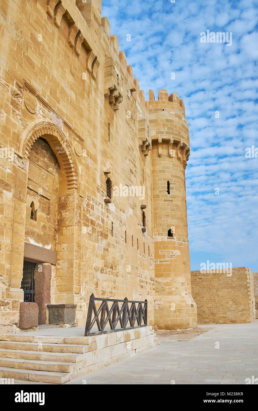 The facade wall of Qaitbay Fort with the entrance gate and huge tower ...