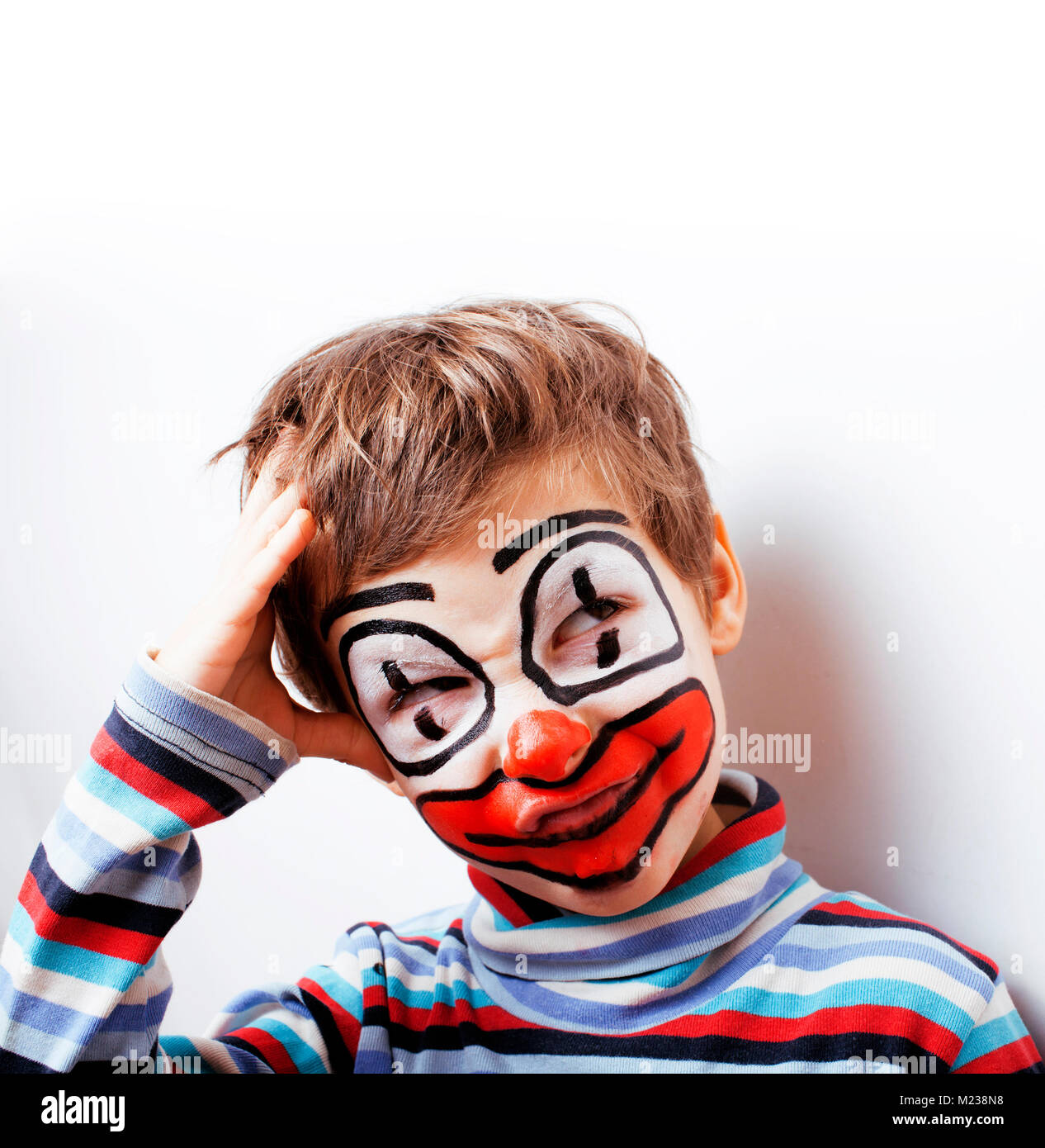 little cute boy with facepaint like clown, pantomimic expressions close ...