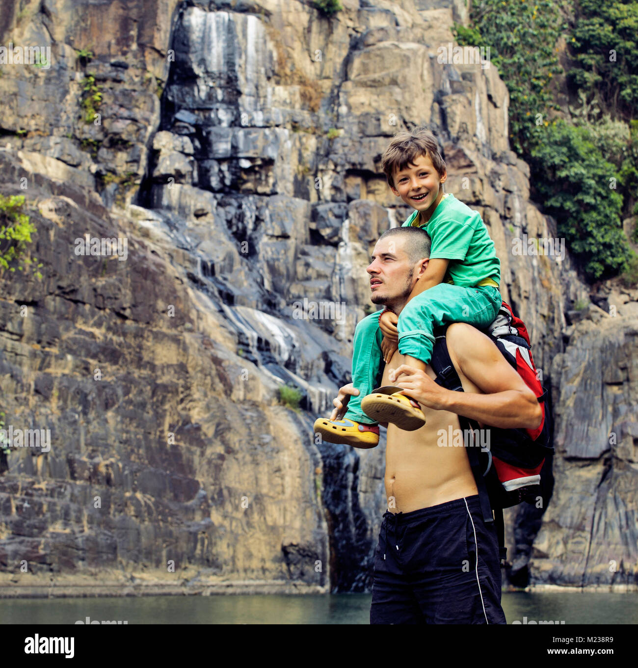 father and son making a trip to waterfall together, happy family Stock ...