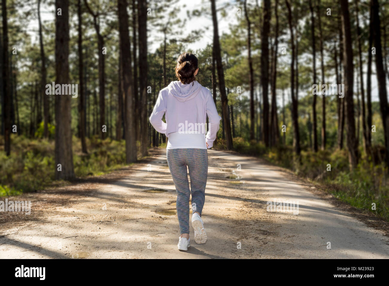 Back view woman jogging alone hi-res stock photography and images - Alamy