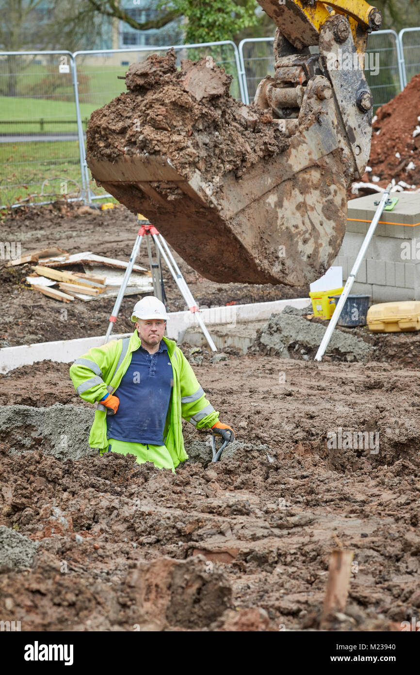 Workers digging the foundations for new homes at Alderley Park in ...