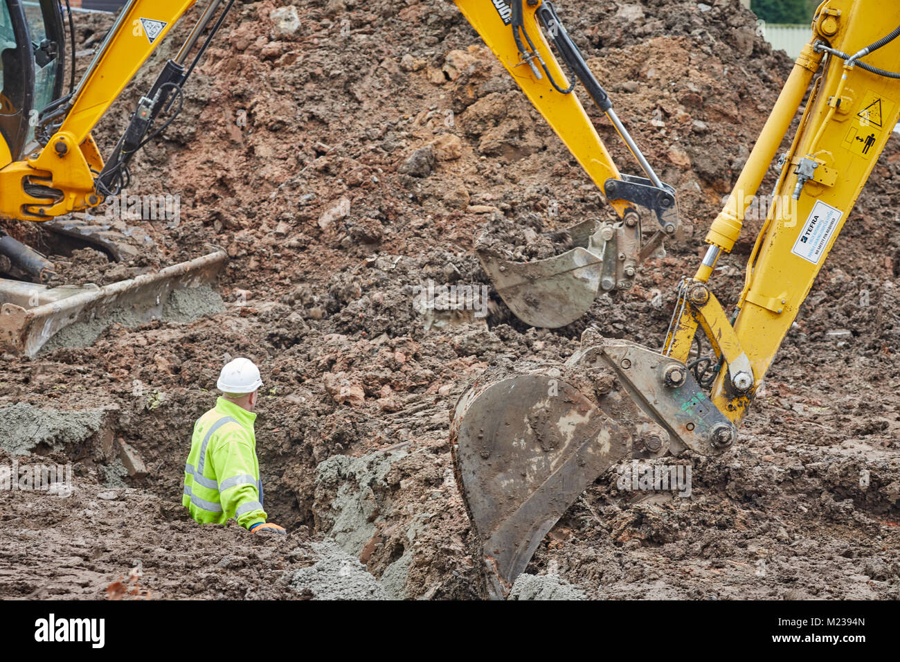 Workers digging the foundations for new homes at Alderley Park in ...