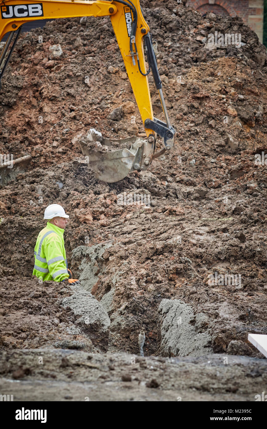 Workers digging the foundations for new homes at Alderley Park in ...
