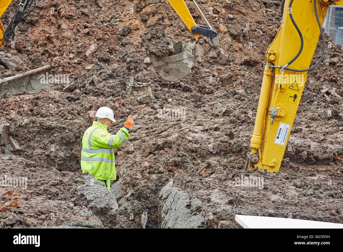 Workers digging the foundations for new homes at Alderley Park in ...