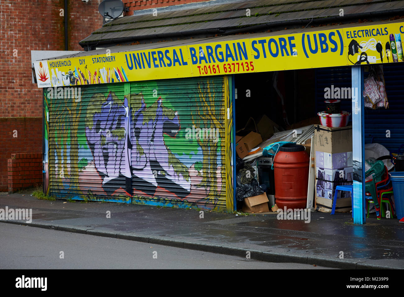 Moss side Manchester, shop on Claremont Road with Graffiti cover ...