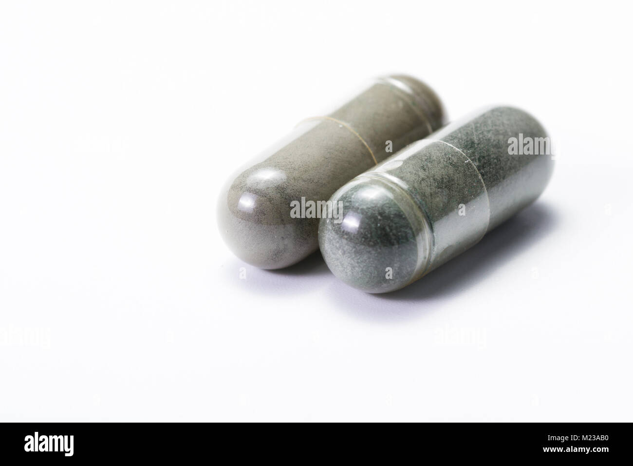 close up of a group of capsule health supplements over a white ...