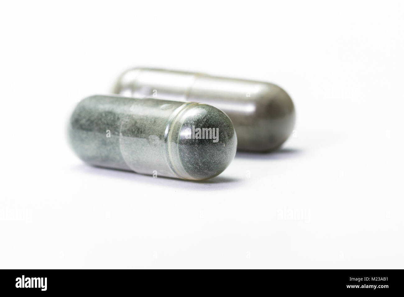 close up of a group of capsule health supplements over a white ...