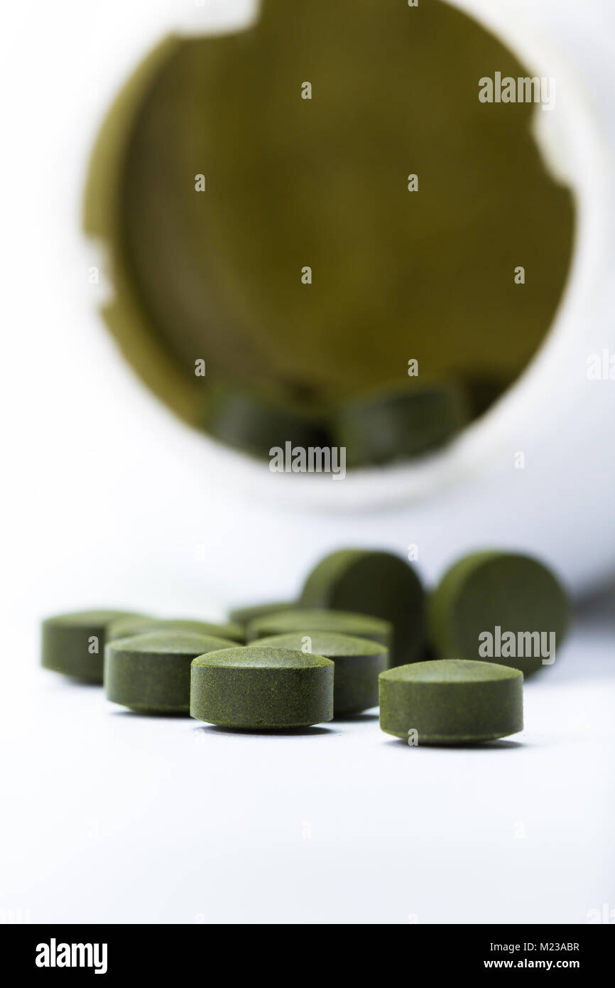 close up of a group of fermented chlorella tablets isolated on a white ...