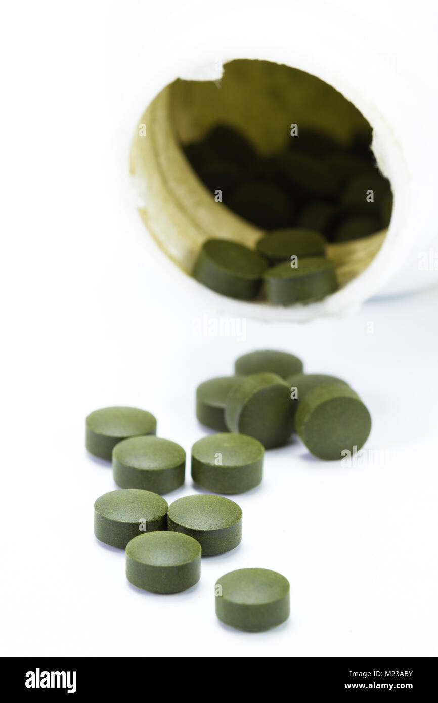 close up of a group of fermented chlorella tablets isolated on a white ...