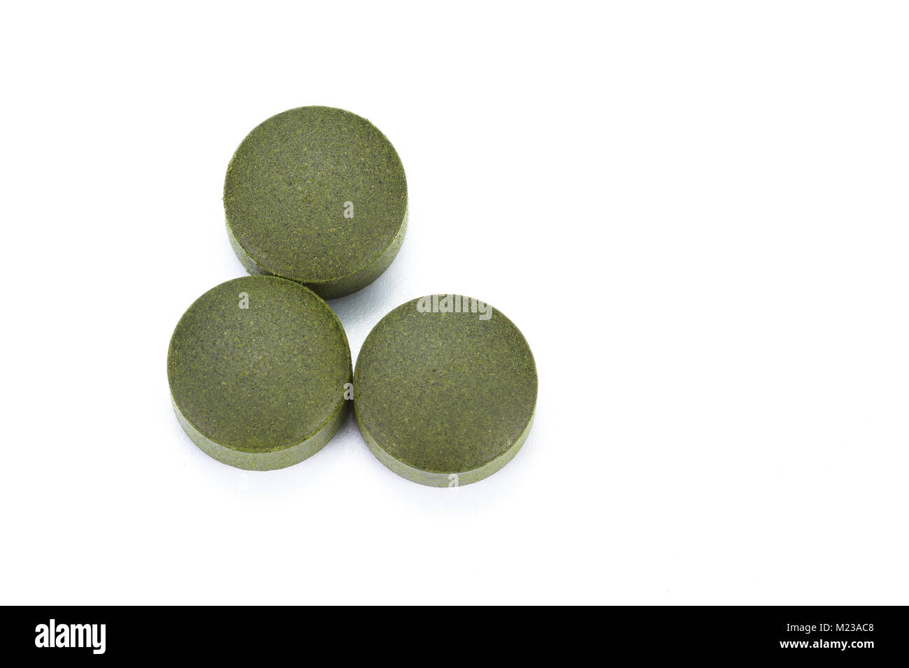 close up of a group of fermented chlorella tablets isolated on a white ...