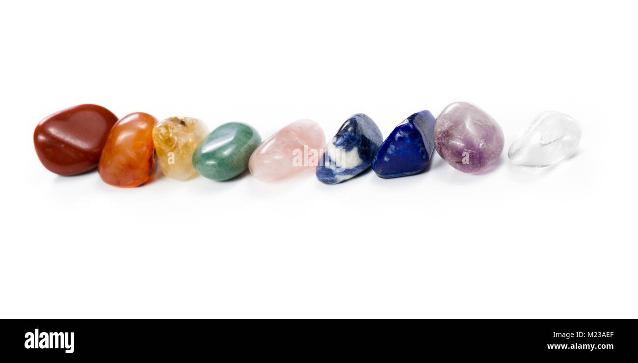 close up of a group of chakra balancing stones isolated on a white ...