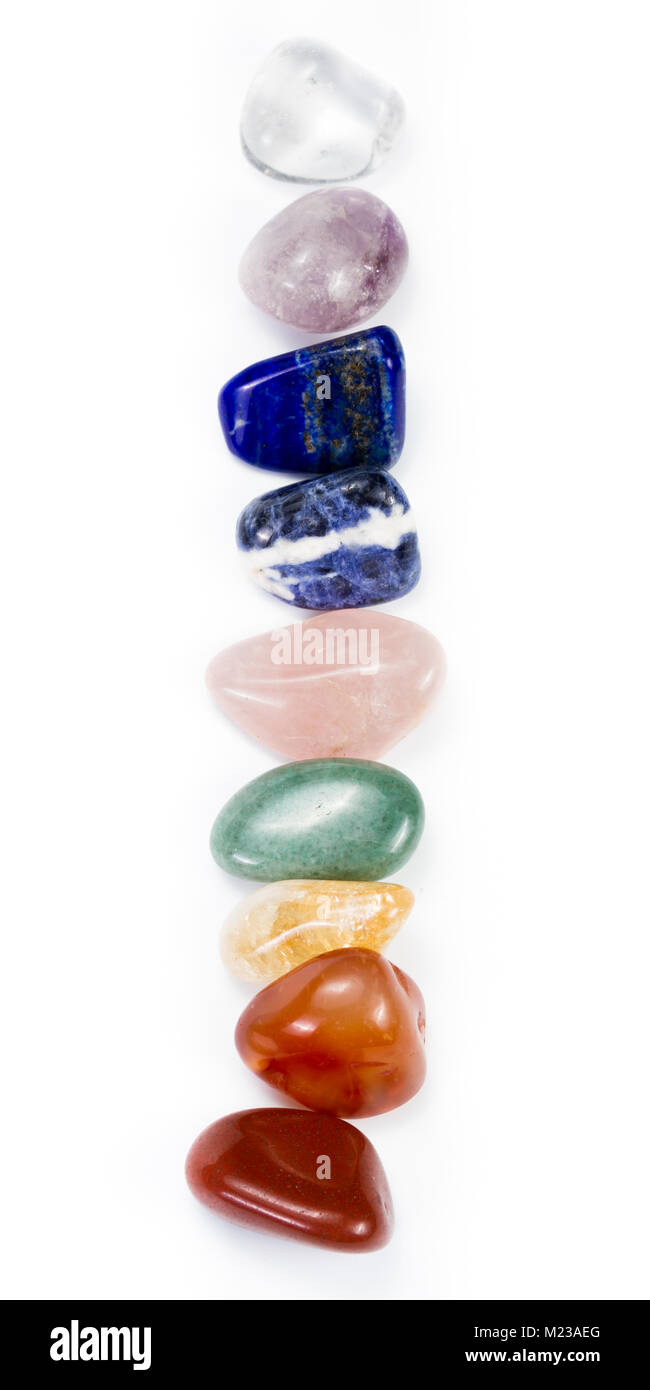 close up of a group of chakra balancing stones isolated on a white ...