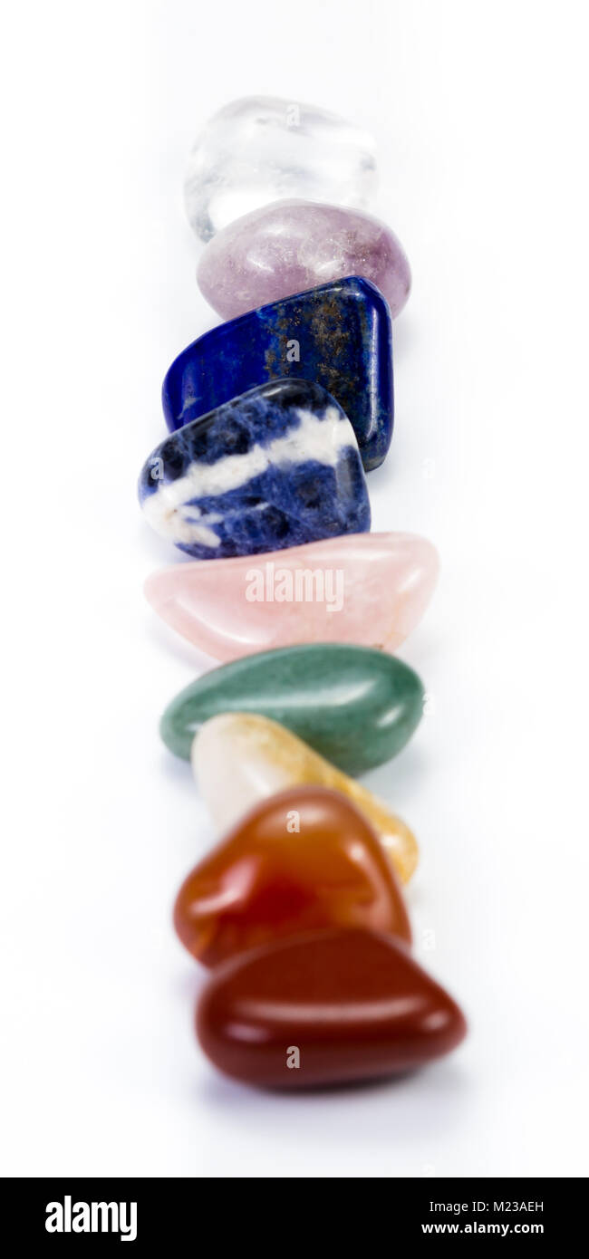 close up of a group of chakra balancing stones isolated on a white ...
