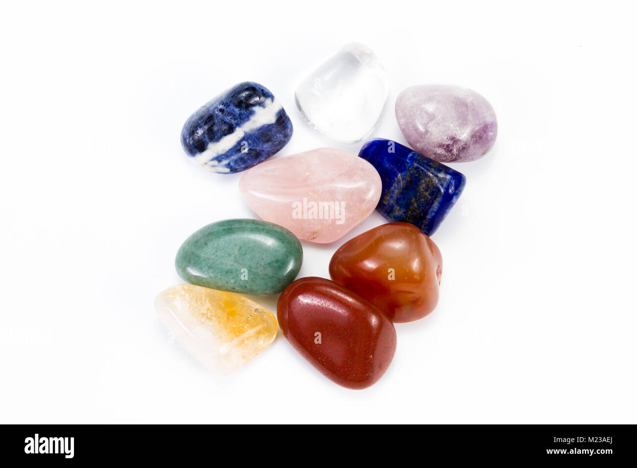 close up of a group of chakra balancing stones isolated on a white ...
