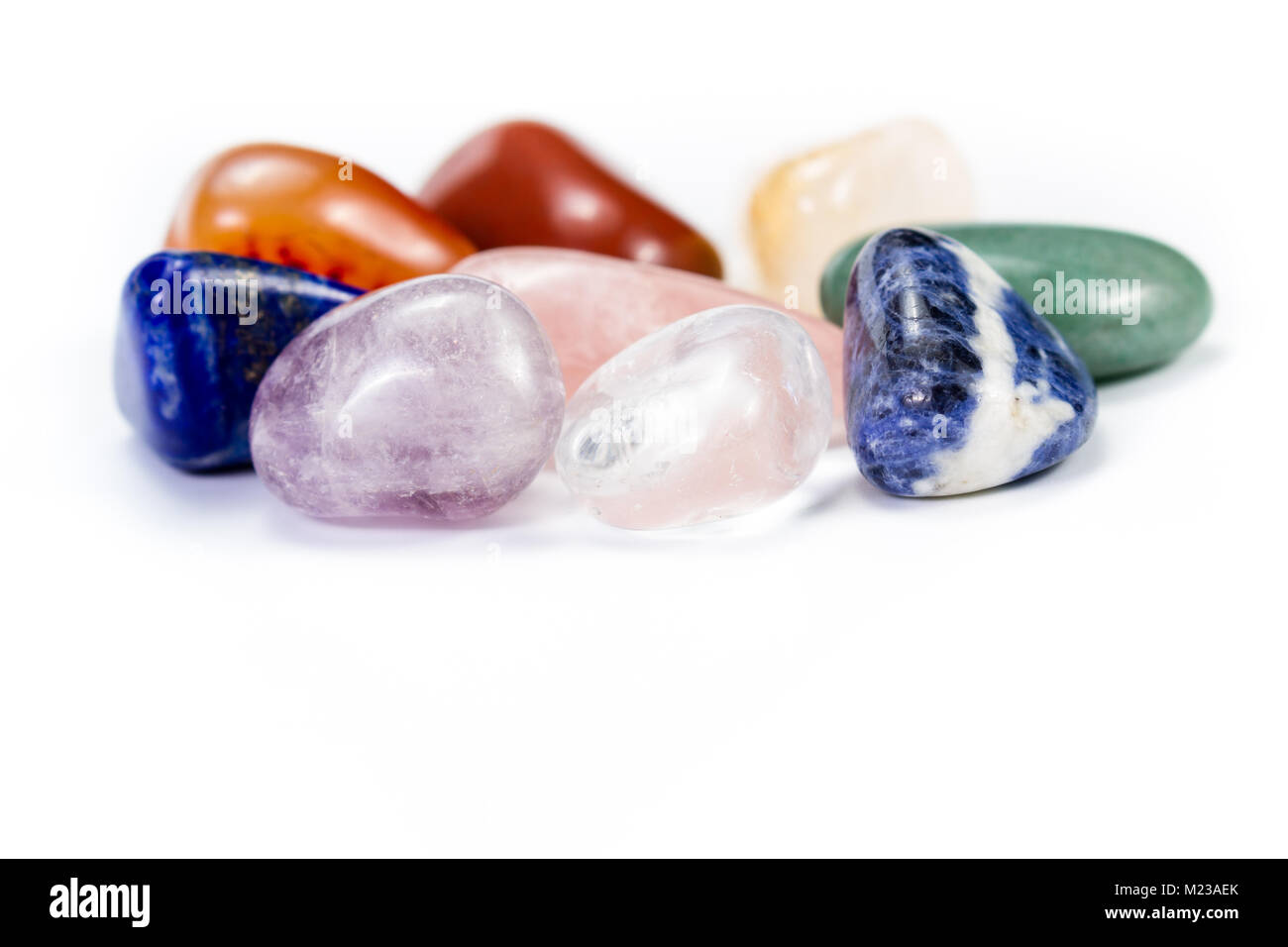 close up of a group of chakra balancing stones isolated on a white ...