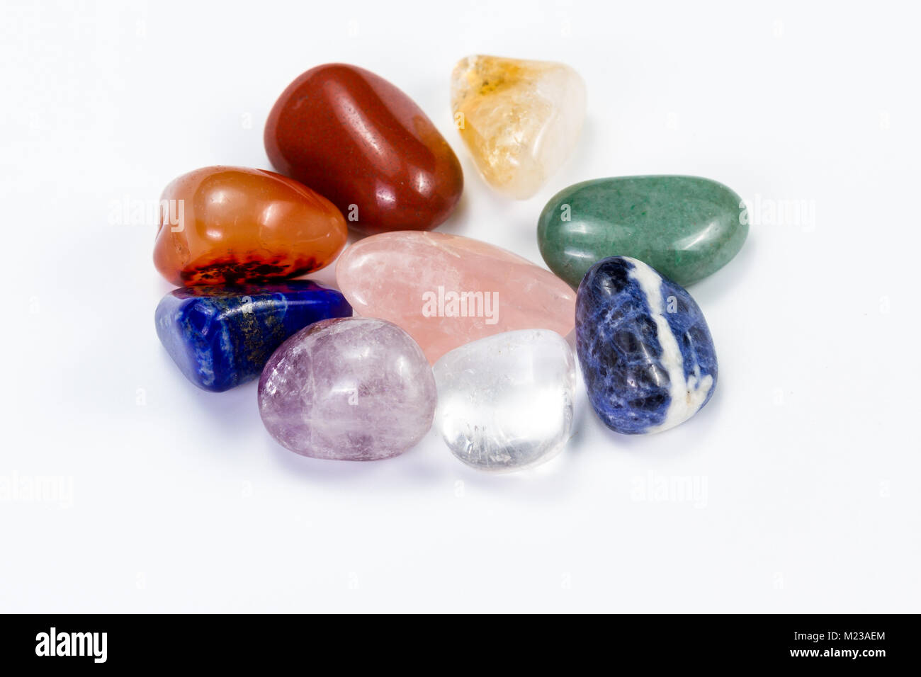 close up of a group of chakra balancing stones isolated on a white ...