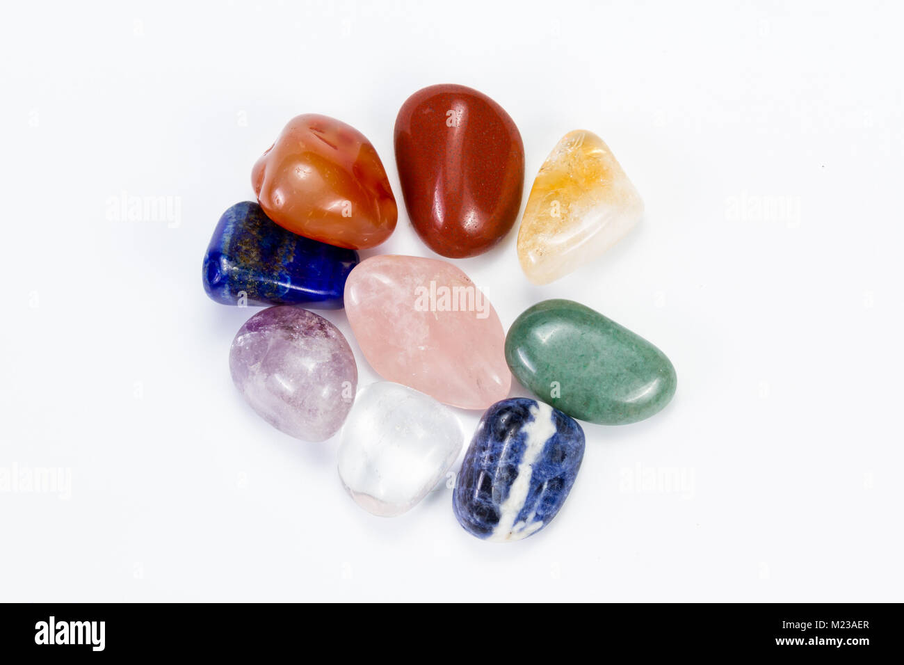 close up of a group of chakra balancing stones isolated on a white ...