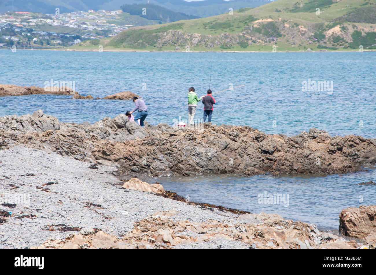 Fishing Off The Rocks Stock Photo - Alamy