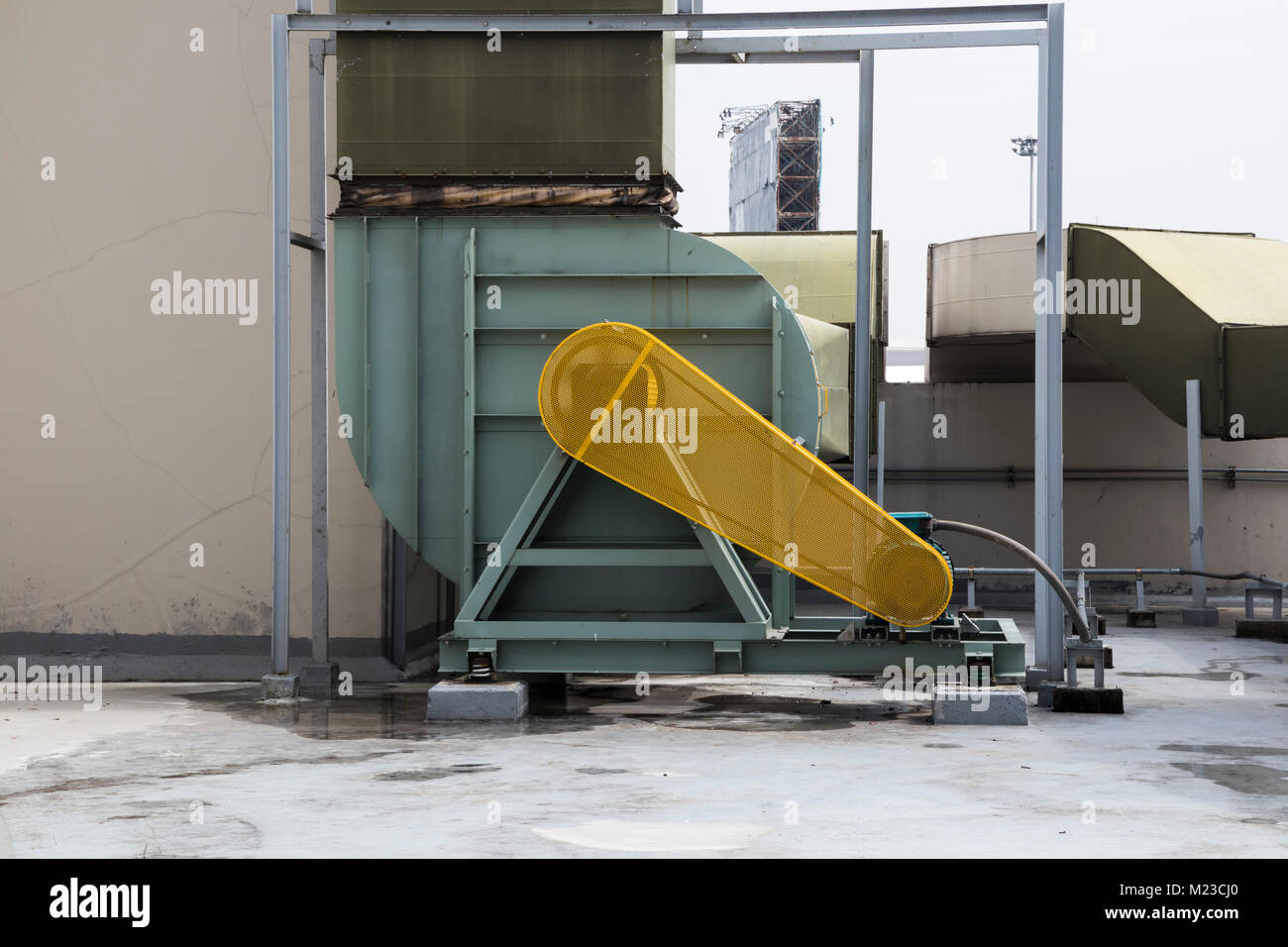 Yellow safety guard motor of air blower for building Stock Photo - Alamy