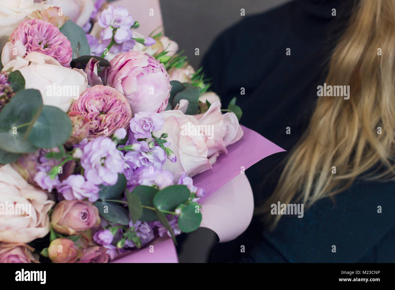 The big delicate bouquet of flowers in rustic style in woman hands ...