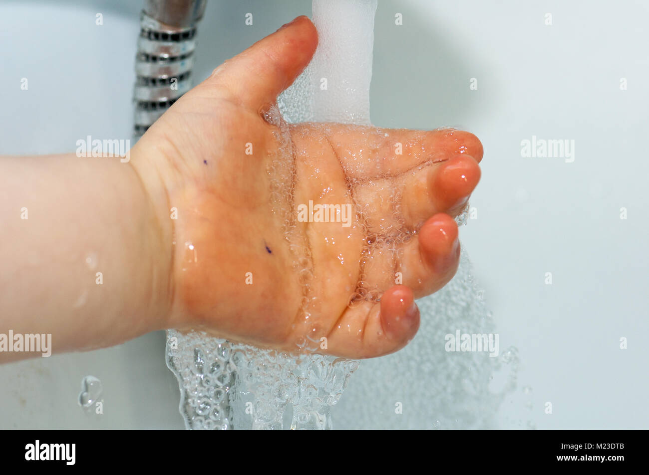 Young Child washing his hands under a tap Stock Photo - Alamy
