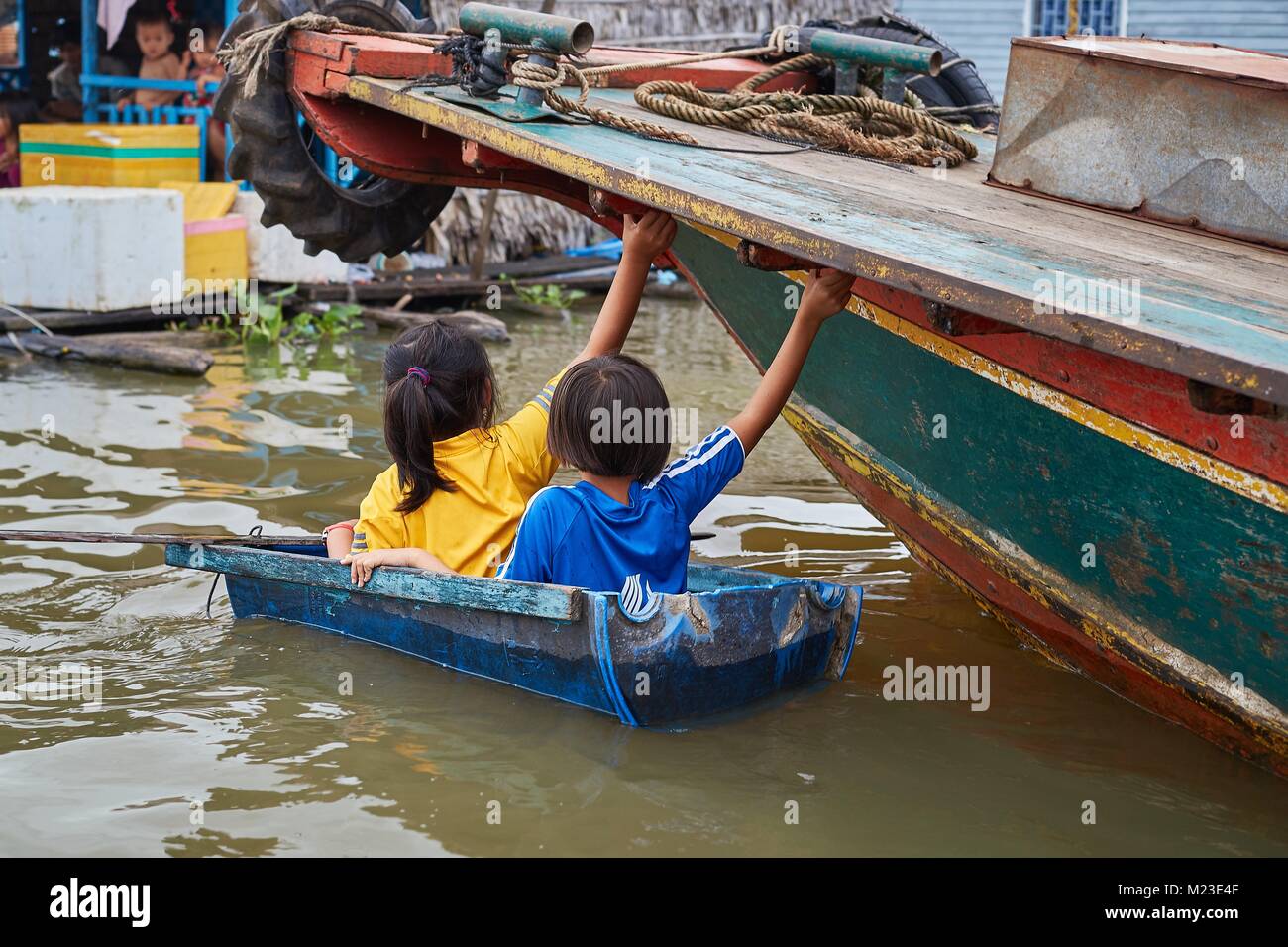 Children rowing on jerrican, Kompong Chhnang, Cambodia Stock Photo - Alamy