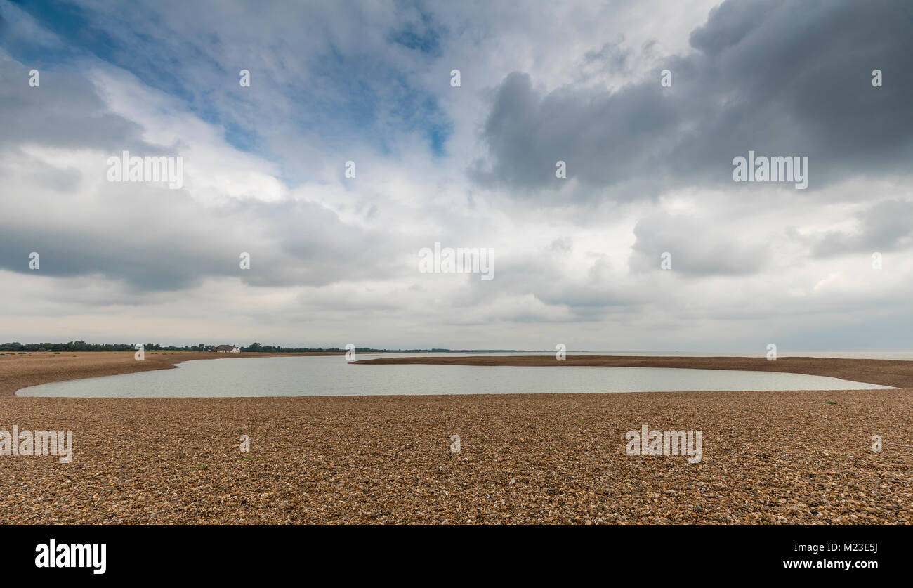 An image of a lagoon with a pebble beach at Shingle Street, suffolk ...