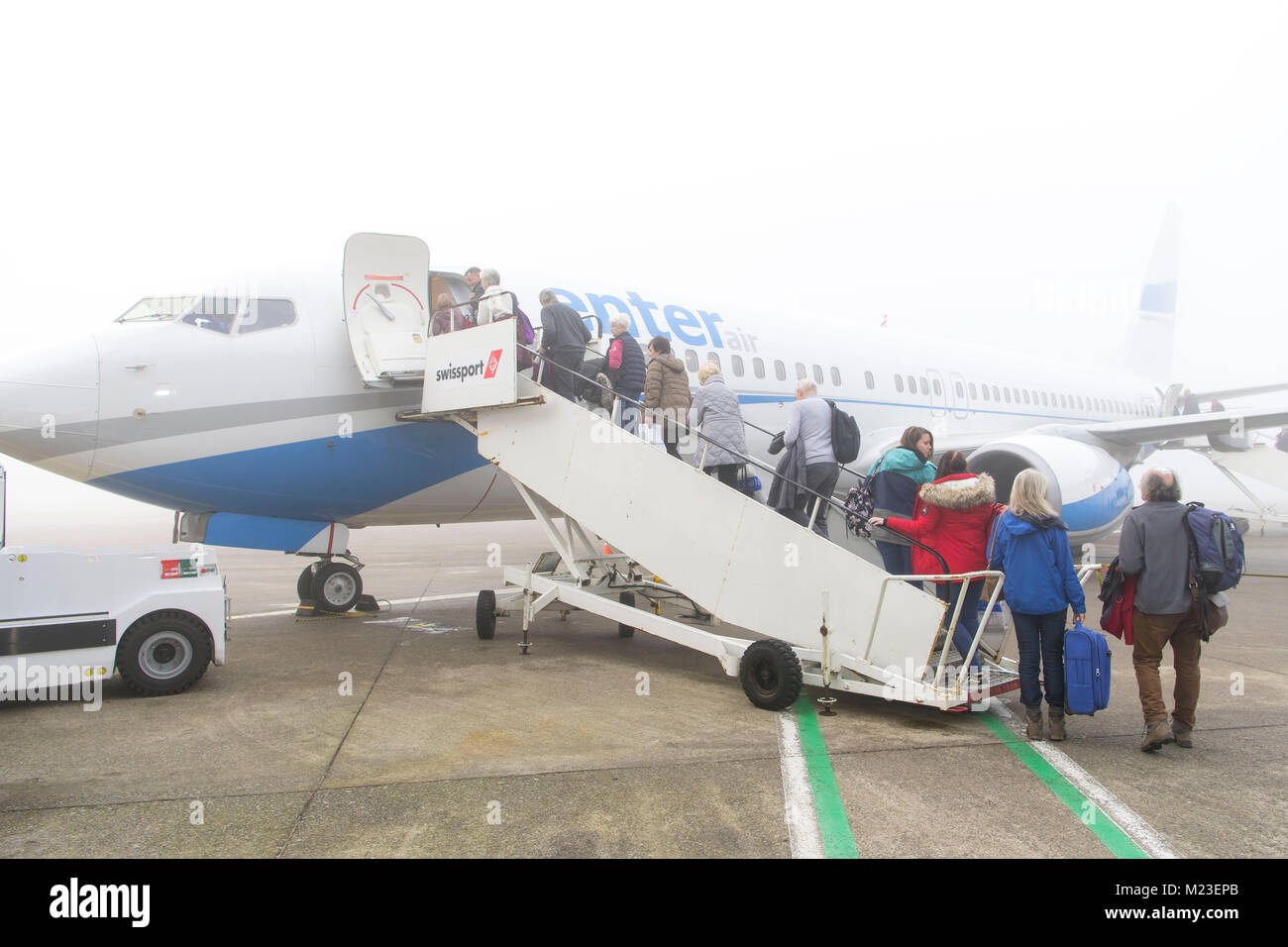 Passengers board an Enter Air airplane Stock Photo - Alamy