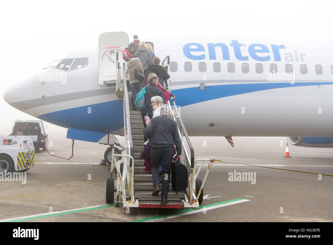 Passengers board an Enter Air airplane Stock Photo - Alamy