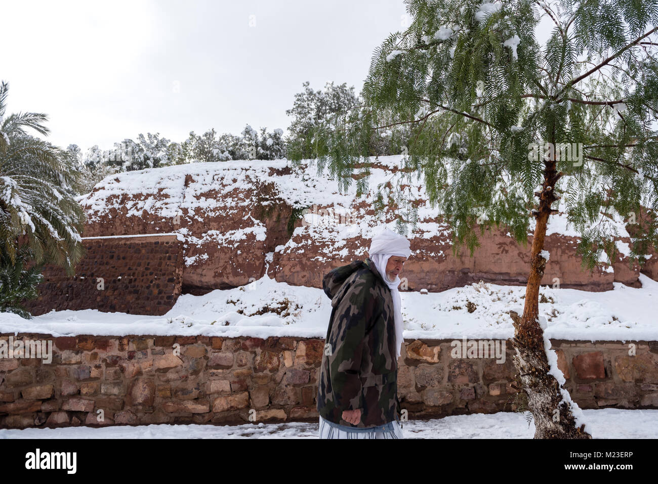 Elder man walking during snow fall, South of Morocco Stock Photo - Alamy