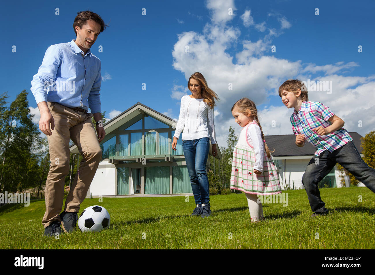 Family kids play soccer together hi-res stock photography and images ...