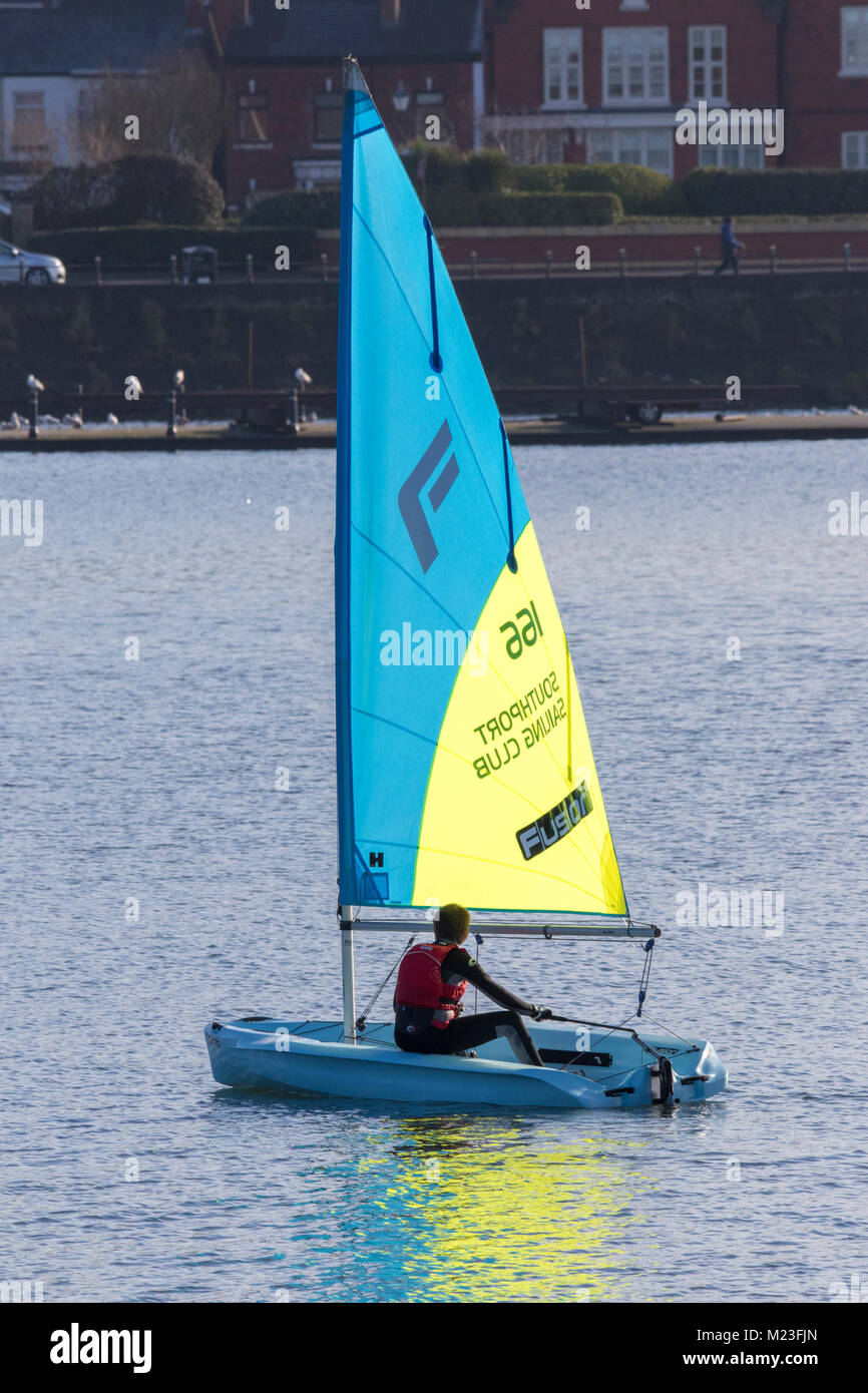 A man sailing a single seat sail boat on Marine boating lake in ...